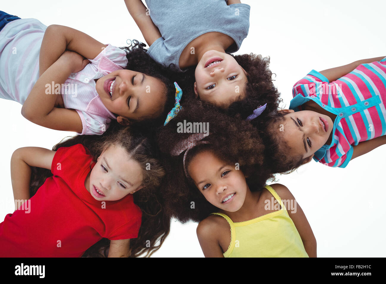 Cute girls laying on a circle Stock Photo - Alamy