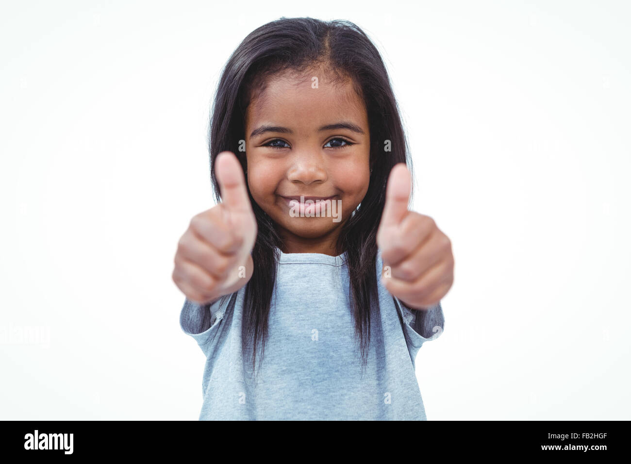 Smiling girl showing thumbs to camera Stock Photo - Alamy