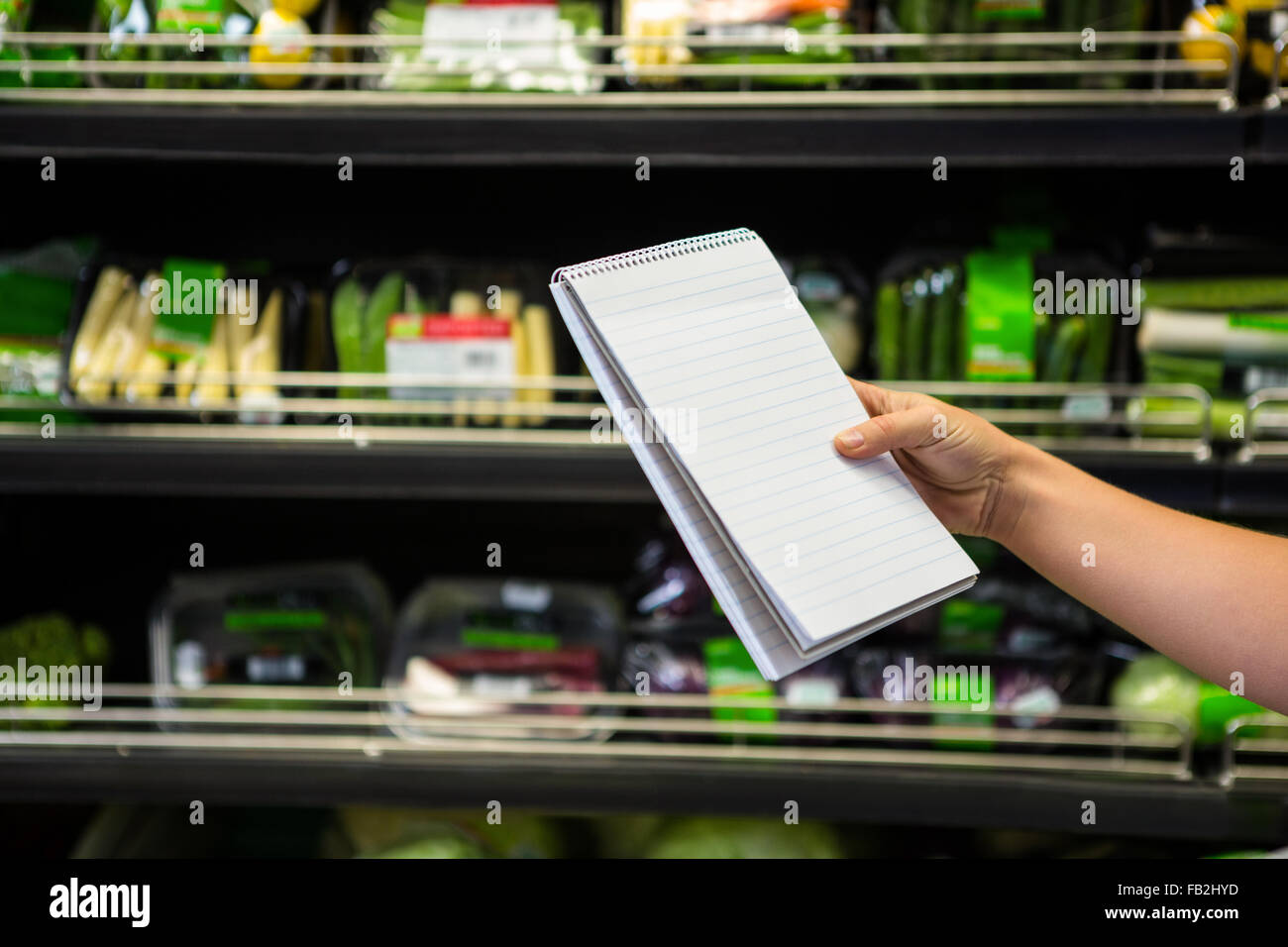 Womans hand holding a list Stock Photo - Alamy