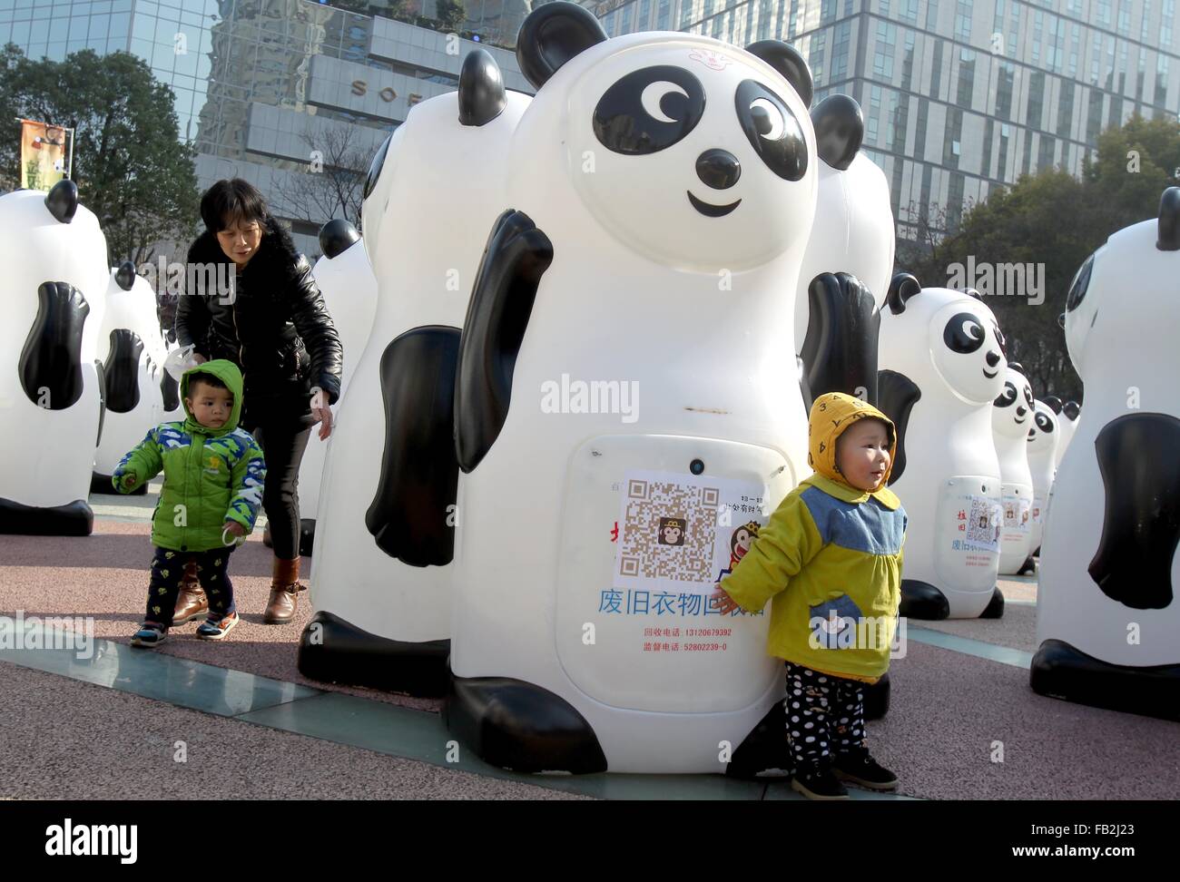 Shanghai, China. 8th Jan, 2016. A child poses for photos with a panda ...