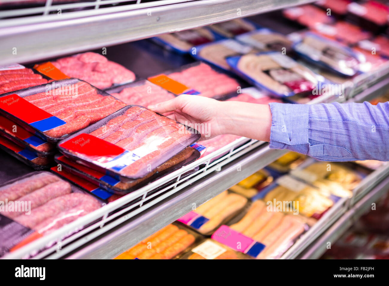 Smiling woman taking meal in the aisle Stock Photo - Alamy