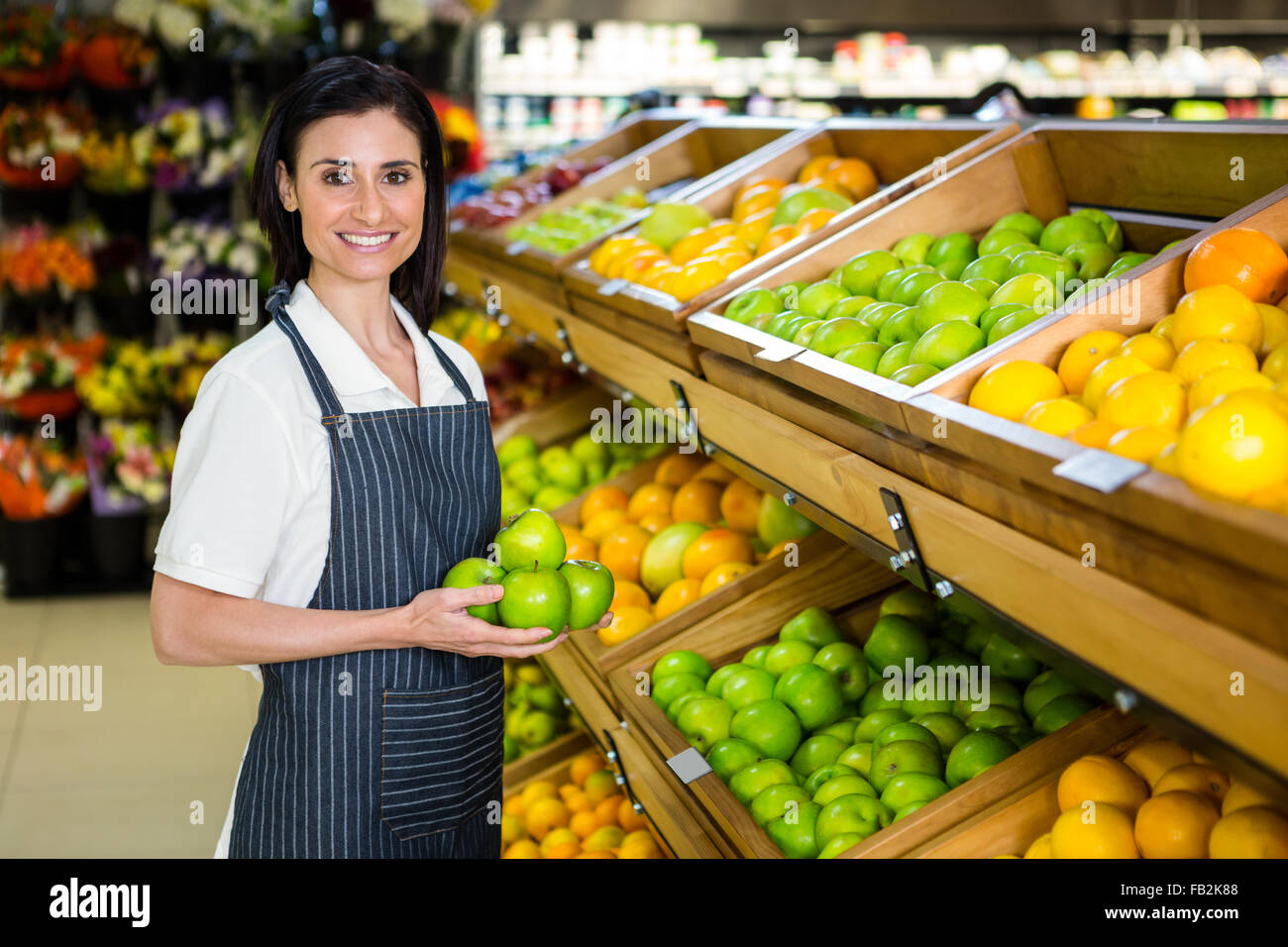 Portrait of a smiling worker taking a fruits Stock Photo - Alamy