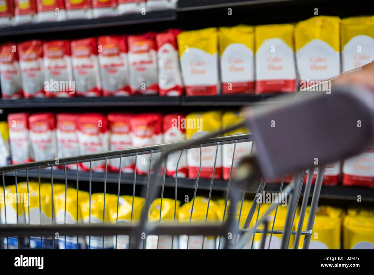 Cropped image of trolley in aisle Stock Photo - Alamy
