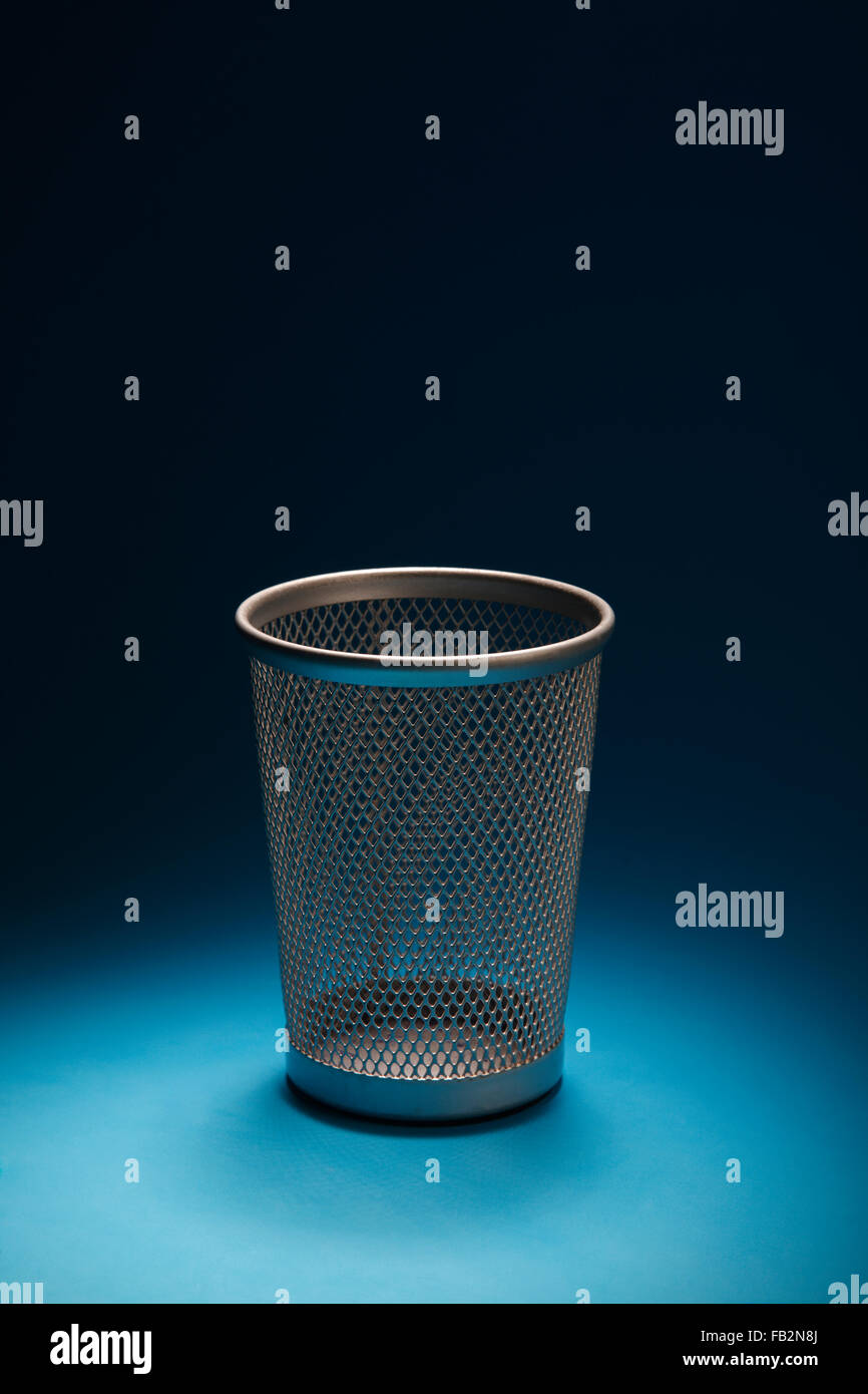 empty trash bin on the blue background Stock Photo - Alamy