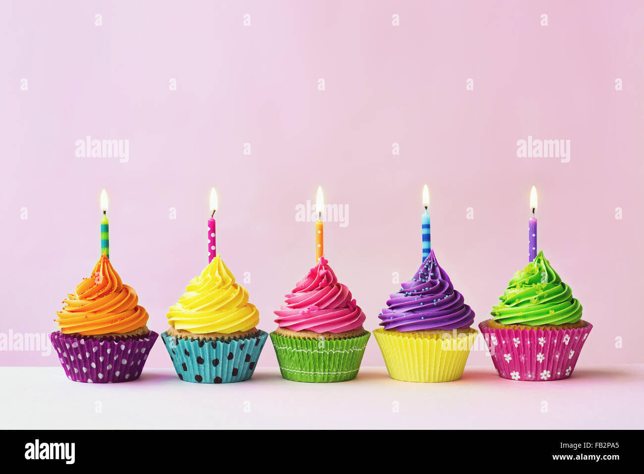 Row of colorful birthday cupcakes Stock Photo - Alamy