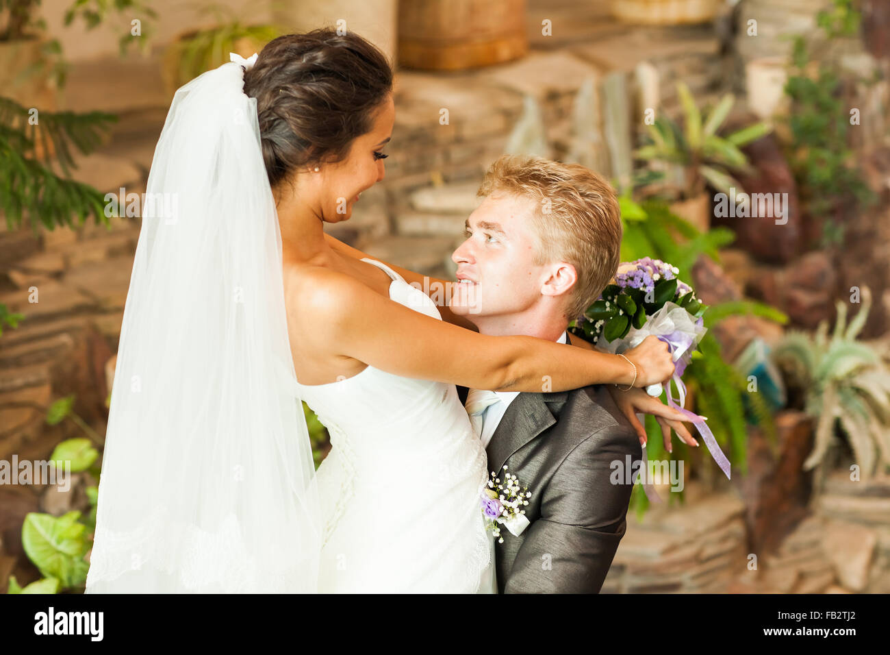 Groom holding bride in dance pose on wedding day Stock Photo - Alamy