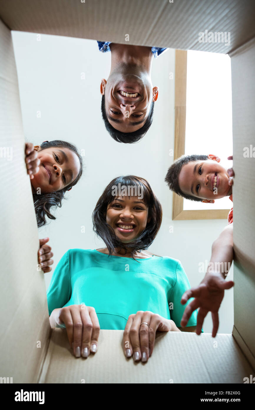 Happy family looking into a box Stock Photo - Alamy