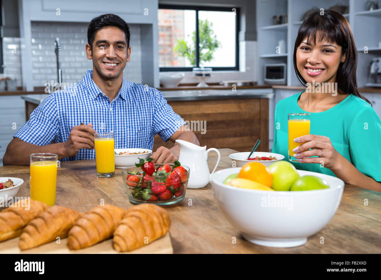 Happy couple having breakfast Stock Photo - Alamy