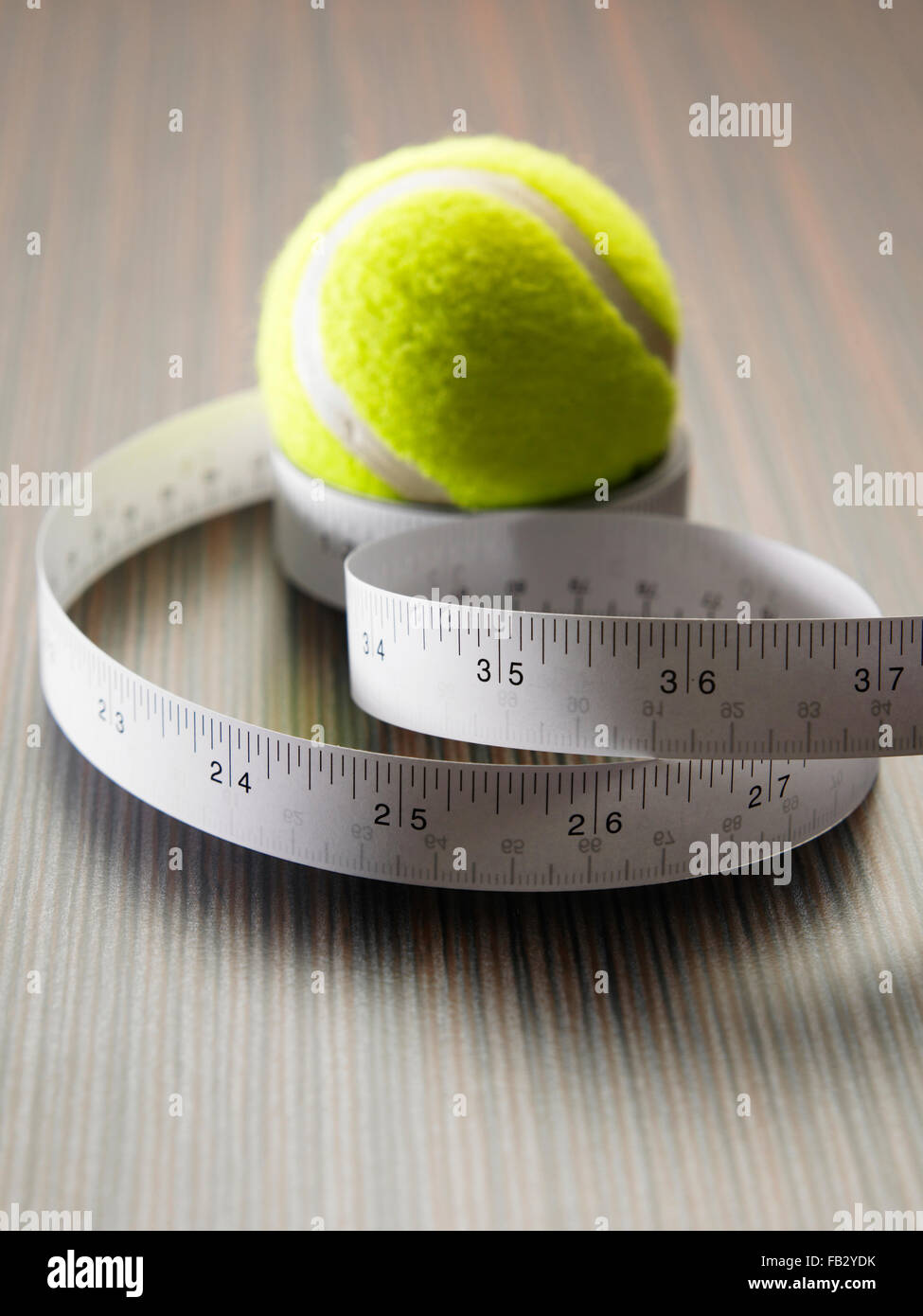 measuring tape with green tennis ball Stock Photo - Alamy