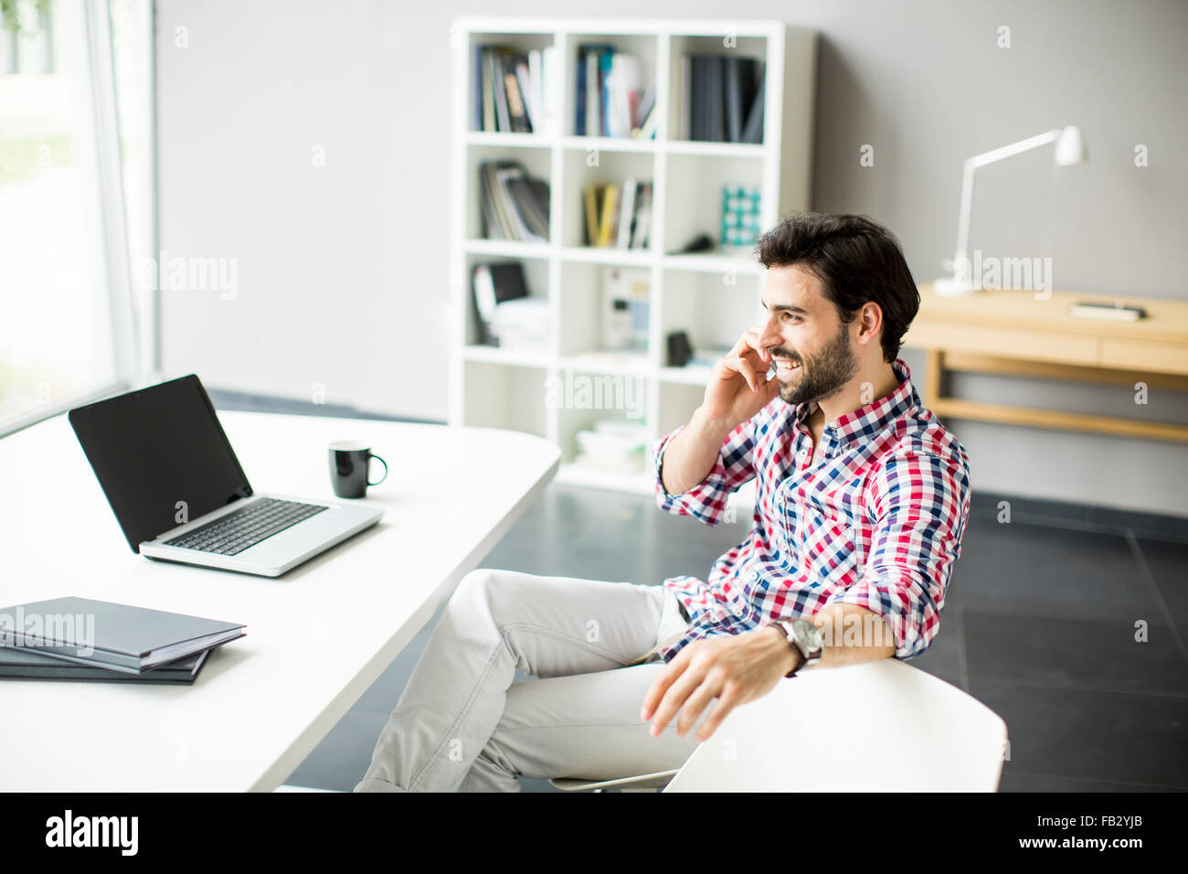 Young man at the office Stock Photo - Alamy