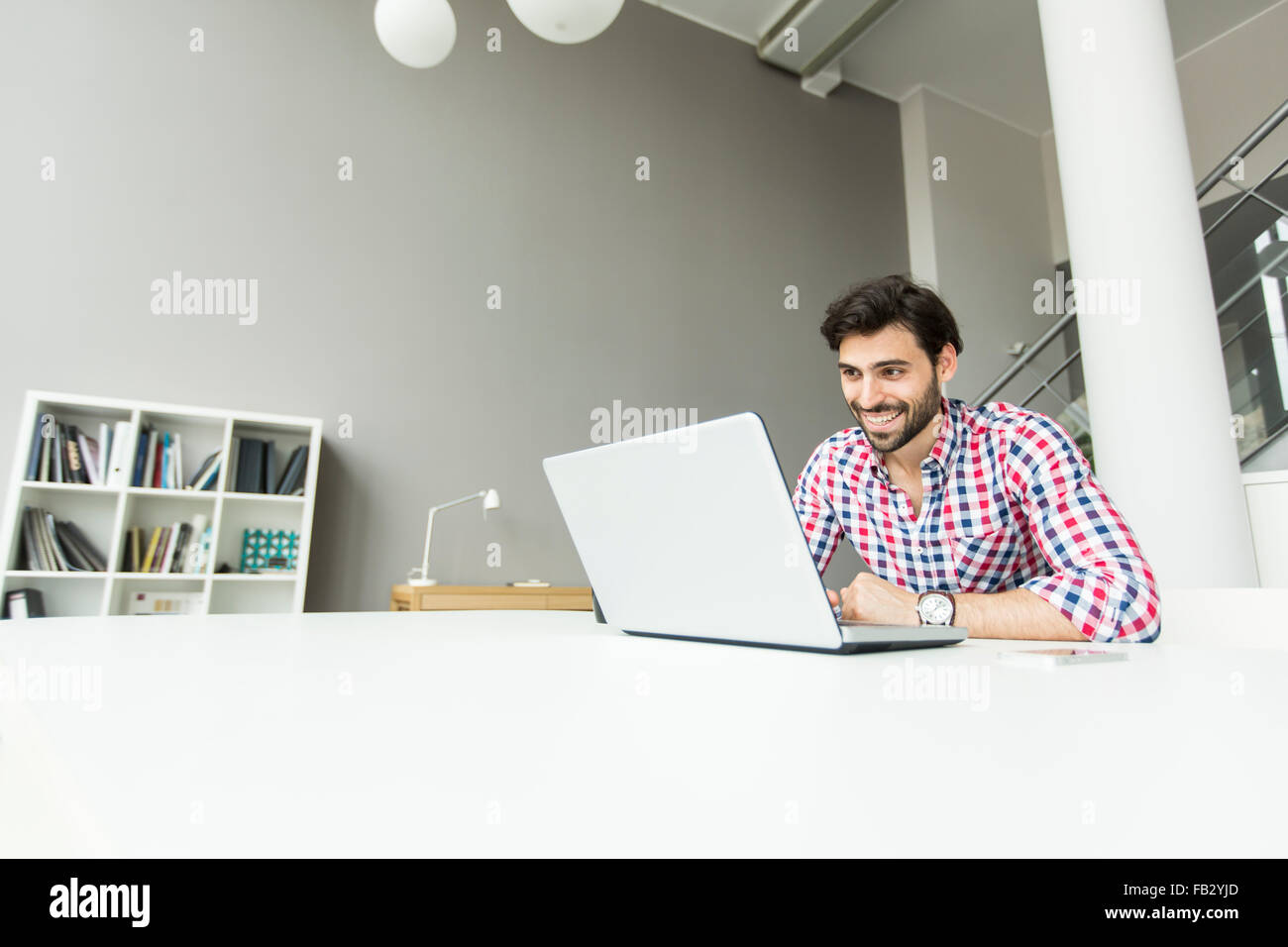 Young man at the office Stock Photo - Alamy