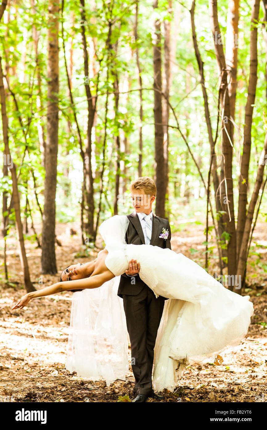Groom holding bride in dance pose on wedding day Stock Photo - Alamy