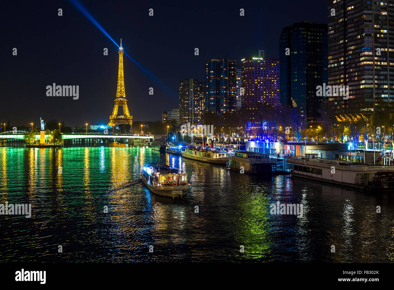 Night view of River Seine with boats and high-rise buildings on the ...