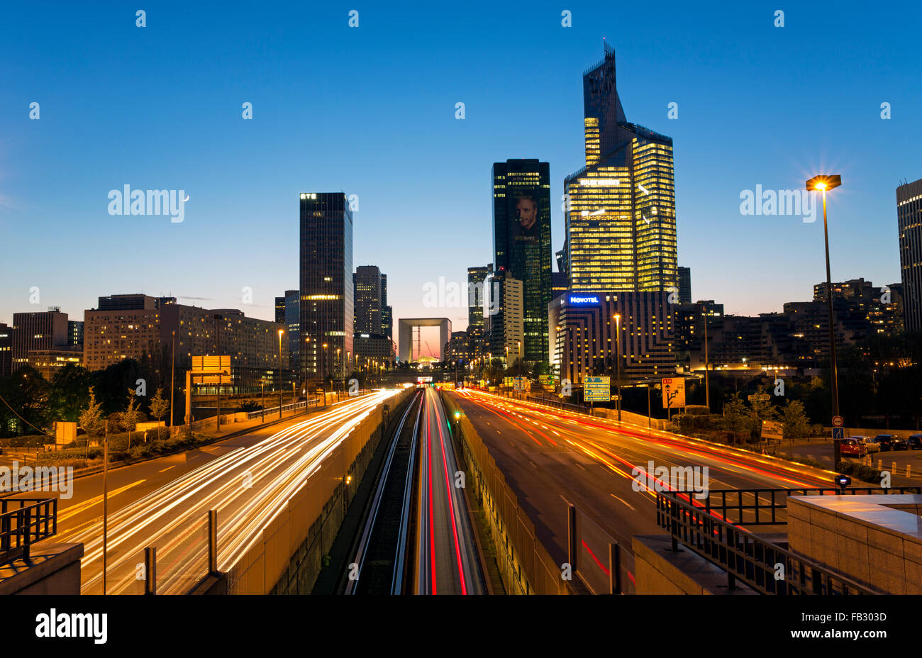 Paris road at night leading towards La Grande Arche and modern office ...