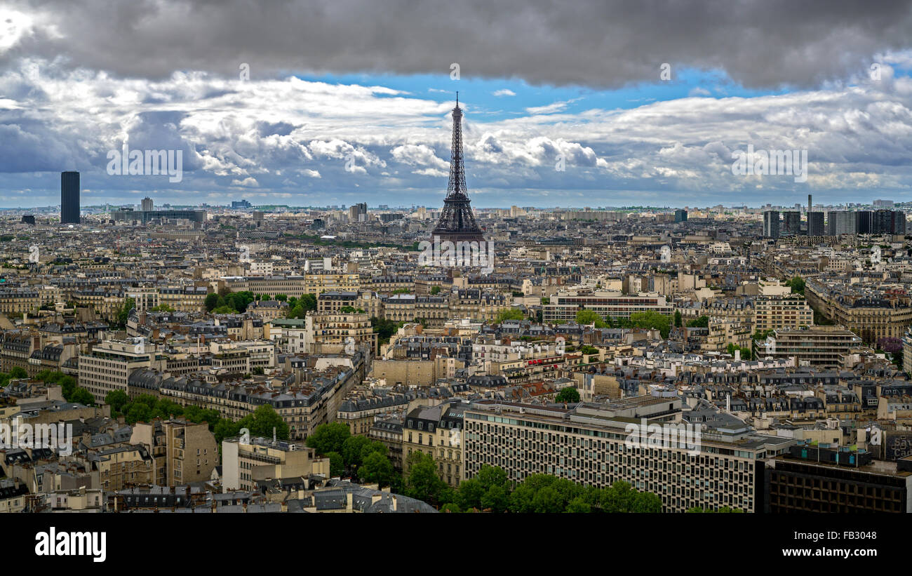 Eiffel Tower, elevated stormy city skyline viewed over rooftops, Paris, France, Europe Stock ...