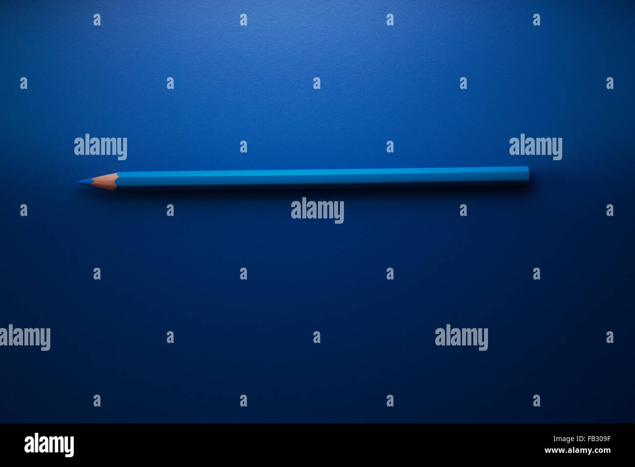 blue color pencil on the blue background Stock Photo - Alamy