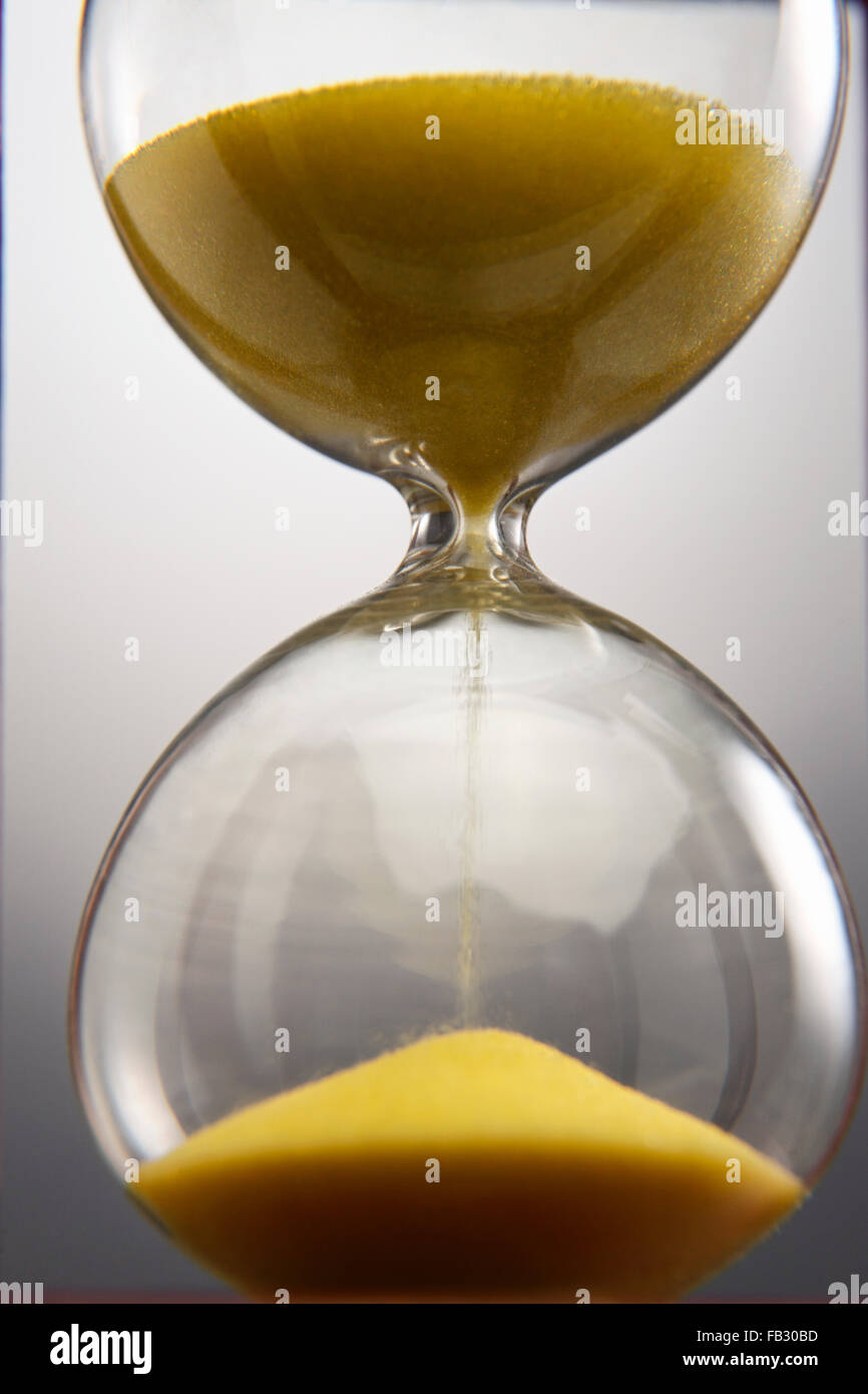 Hourglass - Grains of sand falling down Stock Photo - Alamy