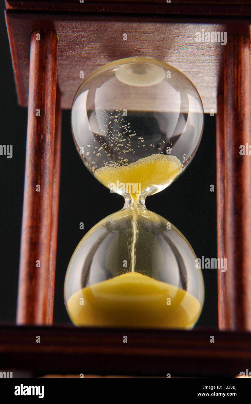 Hourglass - Grains of sand falling down Stock Photo - Alamy