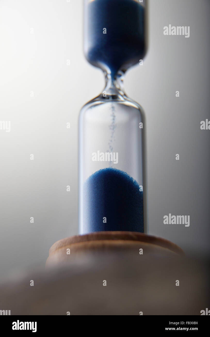Hourglass - Grains of sand falling down Stock Photo - Alamy