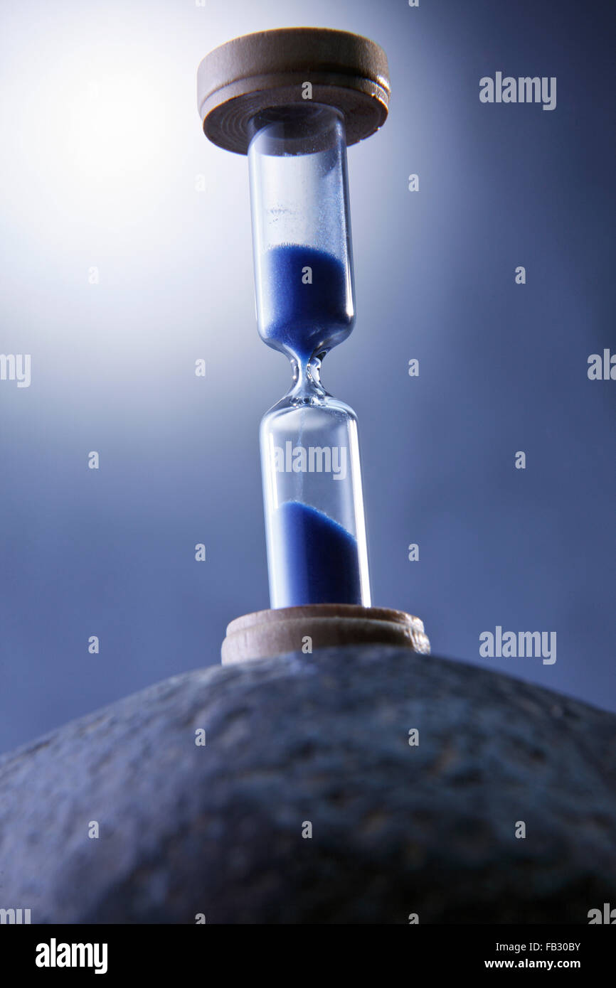 Hourglass - Grains of sand falling down Stock Photo - Alamy