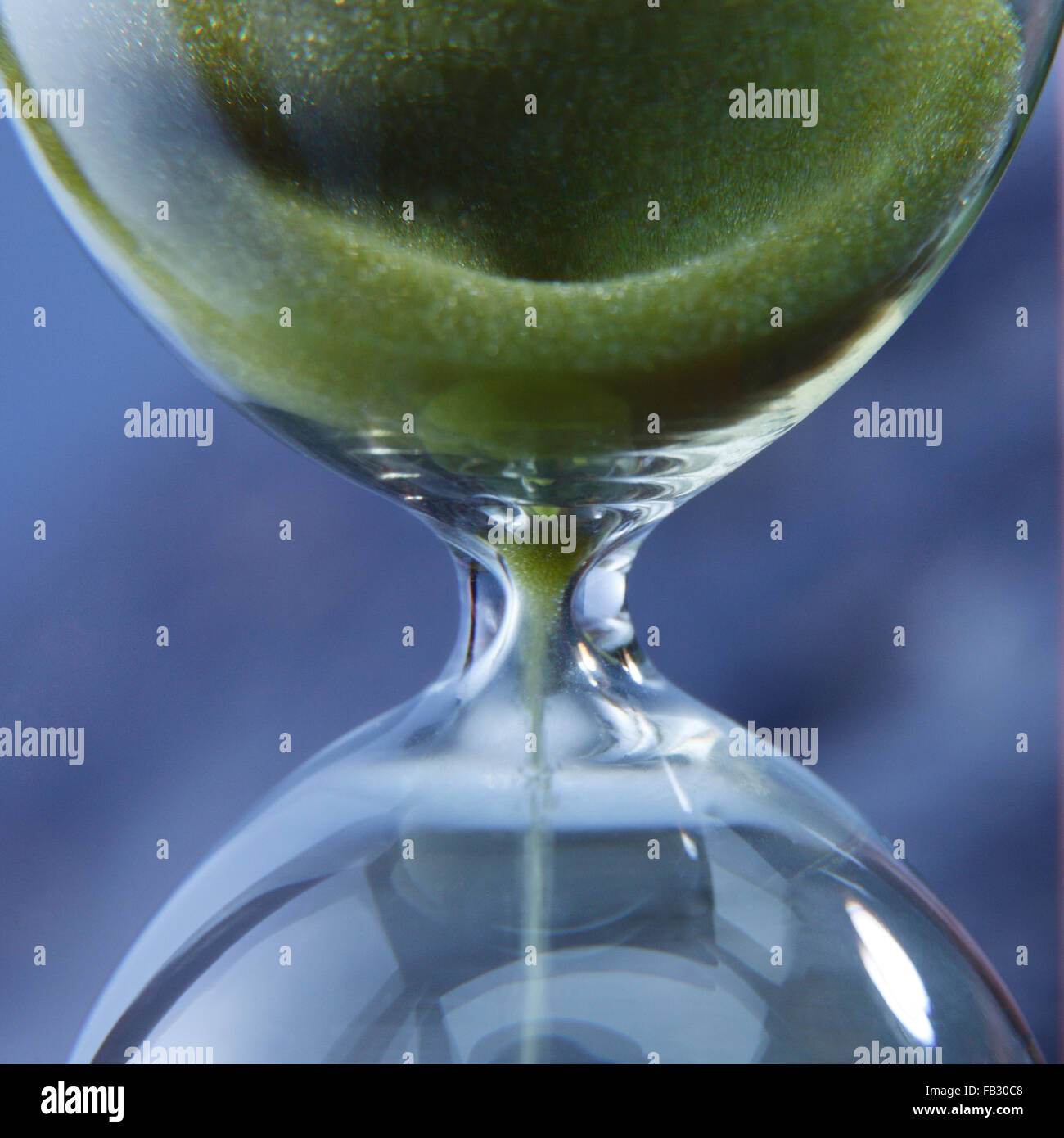 Hourglass - Grains of sand falling down Stock Photo - Alamy
