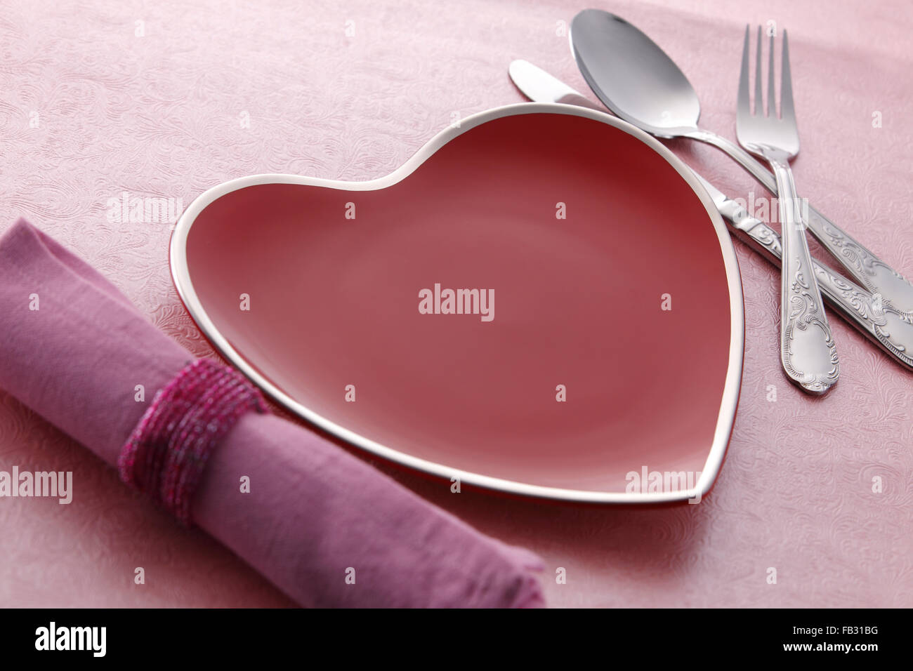 plate with love shape and cutlery Stock Photo - Alamy