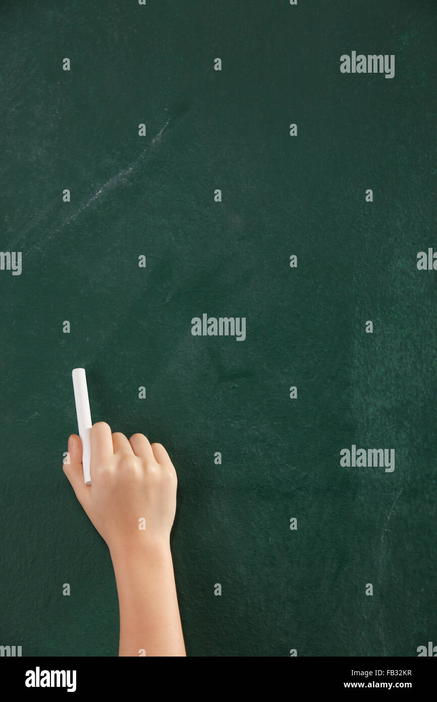 kids hand holding a white chalk about to write Stock Photo - Alamy