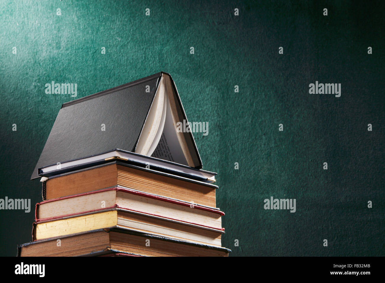 stack of book in front of board Stock Photo - Alamy