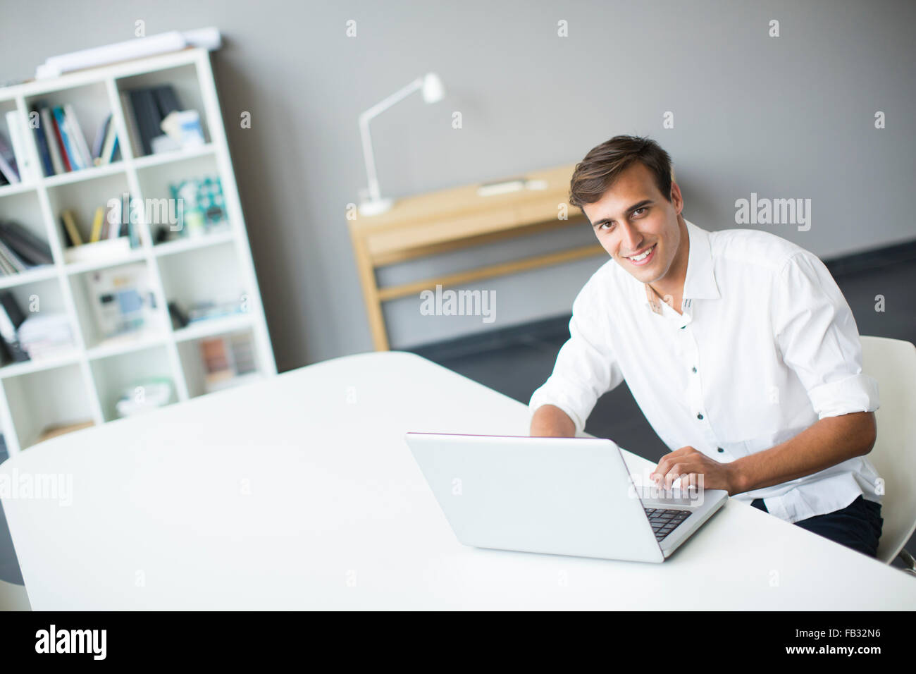 Young man in the office Stock Photo - Alamy
