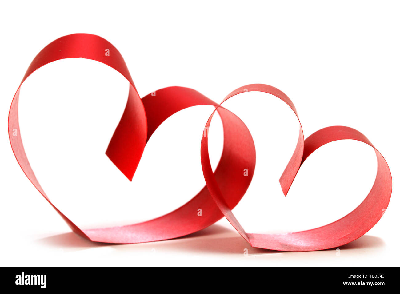 Two linked hearts of red ribbon isolated on white background Stock ...