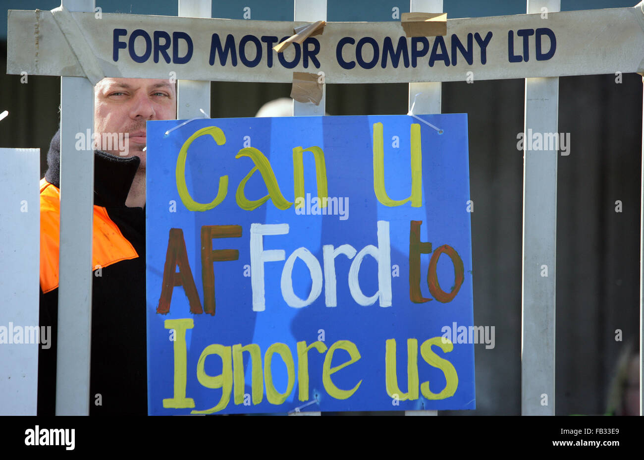 A sit-in worker put up signs for support during a tour of the Visteon ...