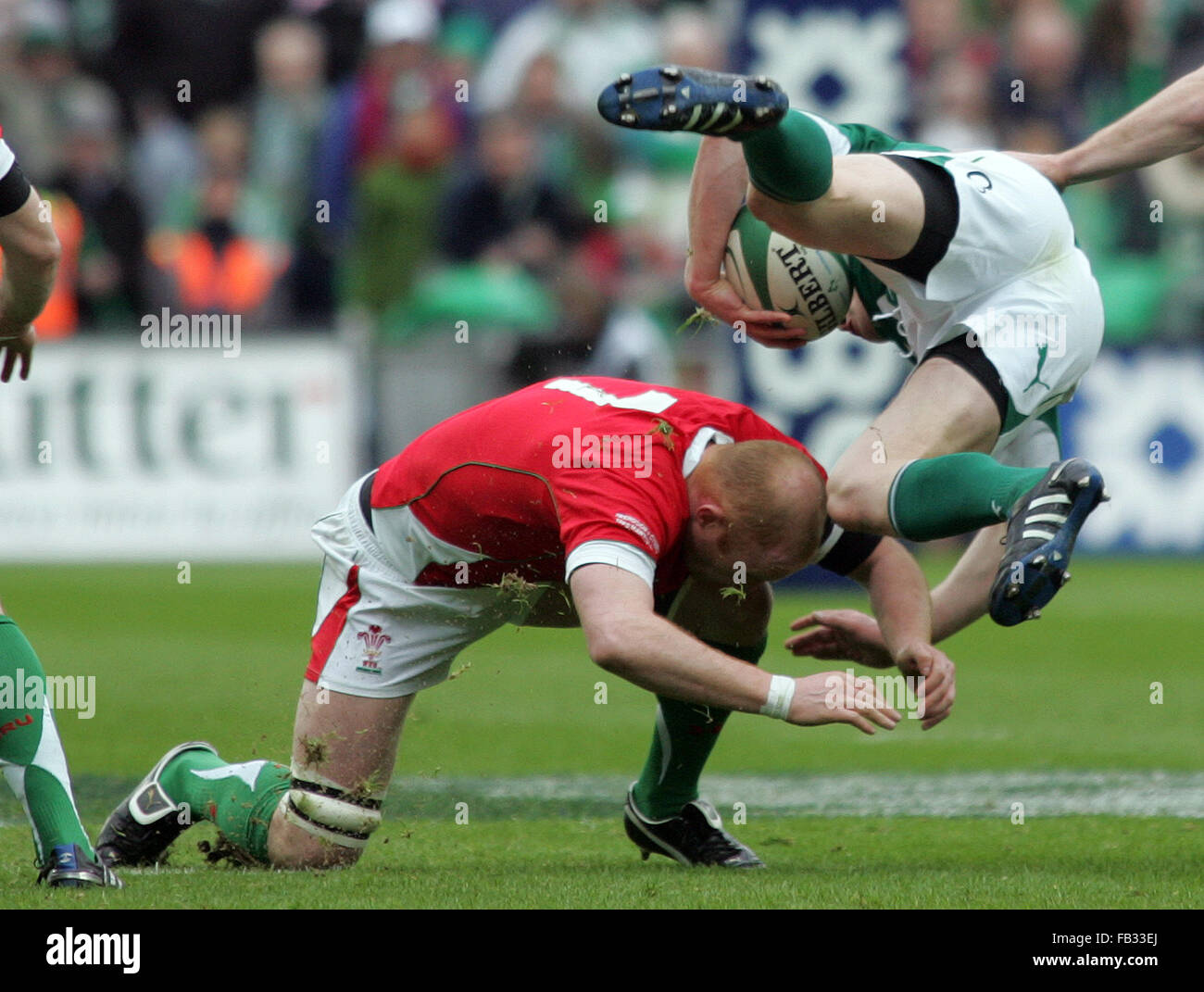 Ireland's Keith Earls is tackled into the air by Wales Martyn Williams ...