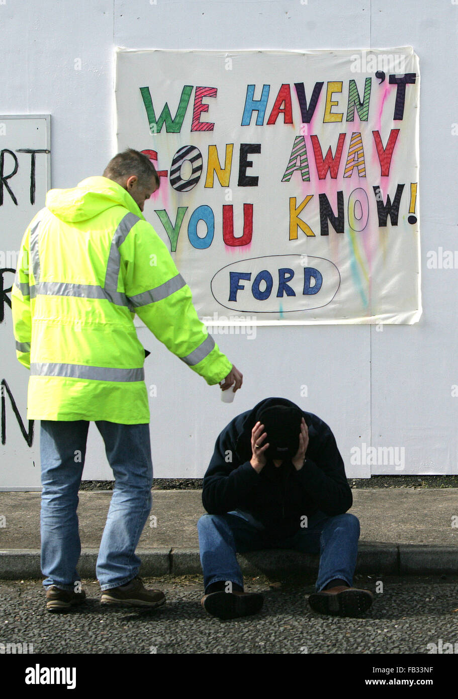 A sit-in worker put up signs for support during a tour of the Visteon ...