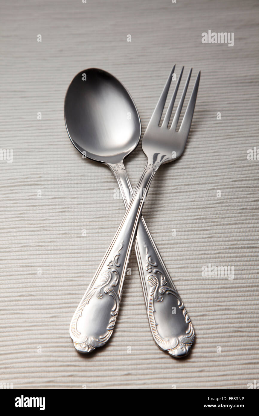 Fork and spoon crossed over Stock Photo - Alamy