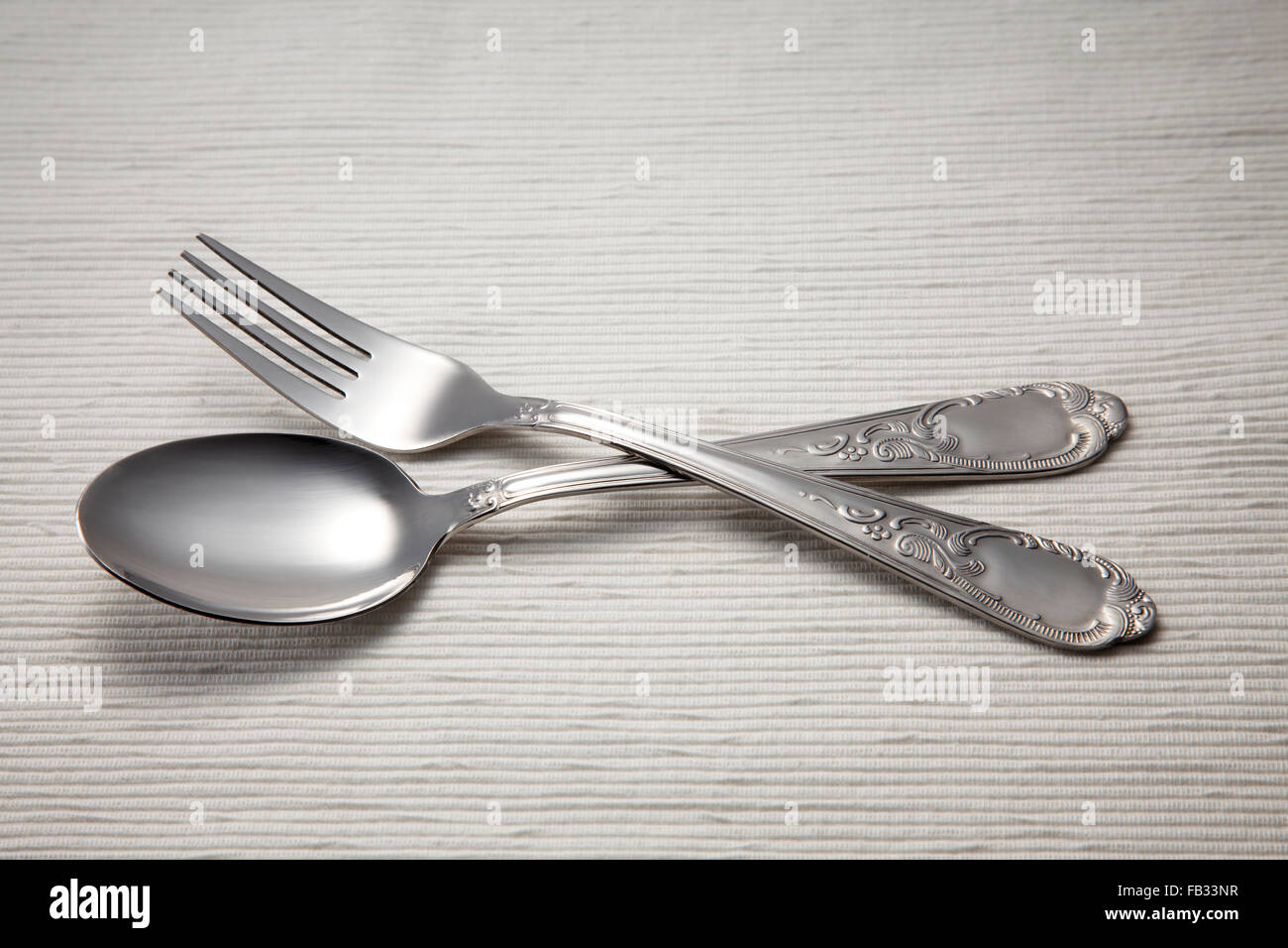 Fork and spoon crossed over Stock Photo - Alamy