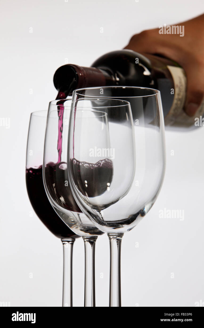 Wine glass being filled up with wine Stock Photo - Alamy