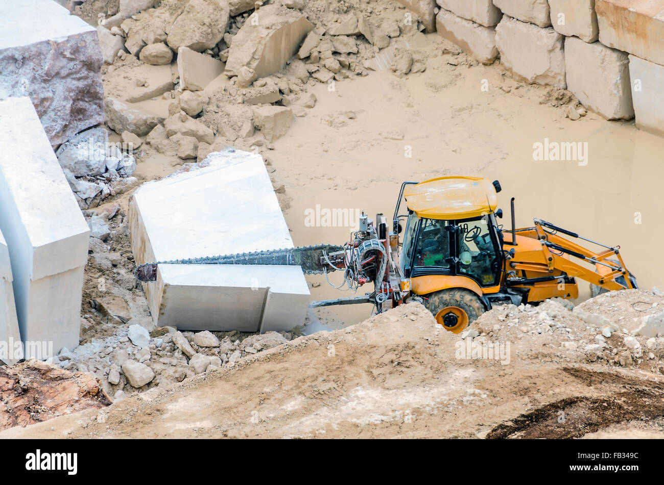 Industrial marble quarry, with cut blocks and workers and machines ...