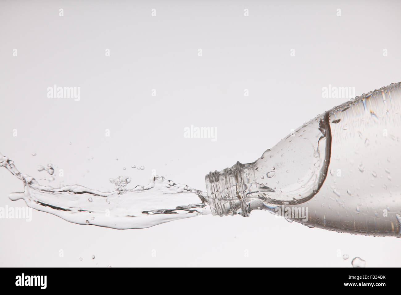 bottle with water splash out Stock Photo - Alamy