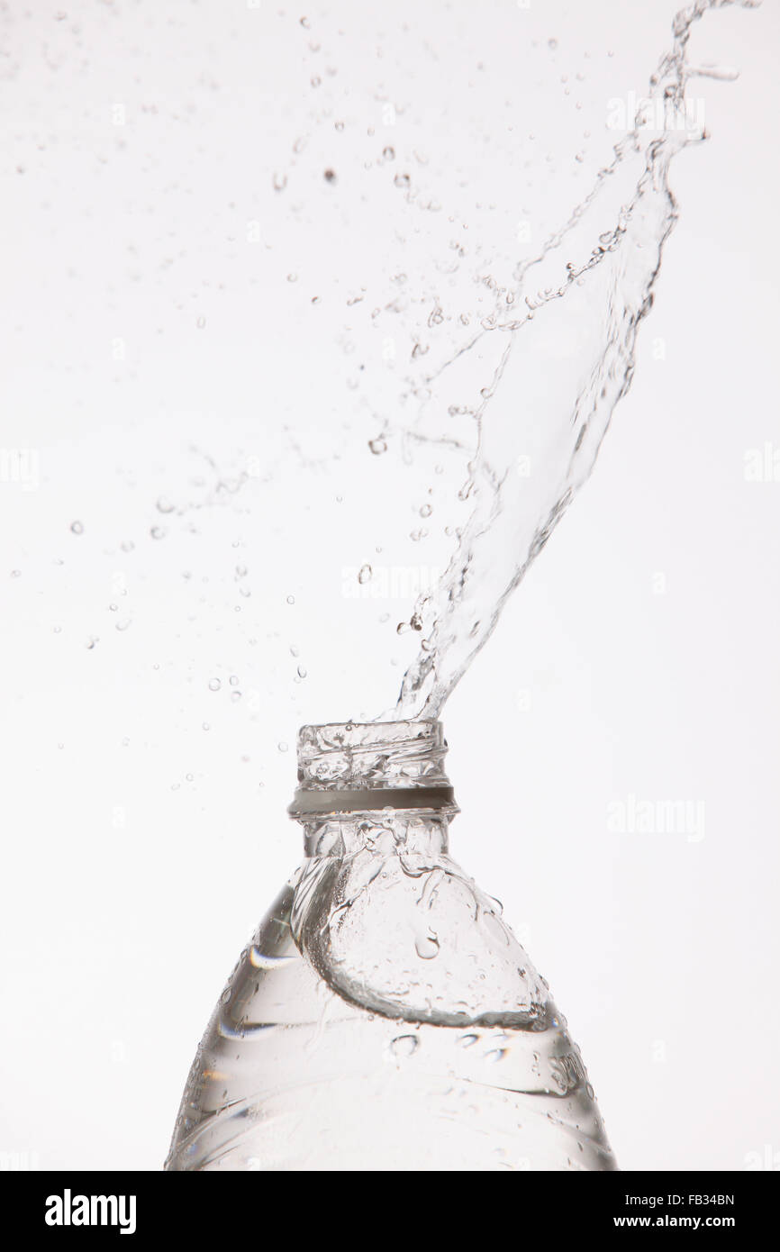 bottle with water splash out Stock Photo - Alamy