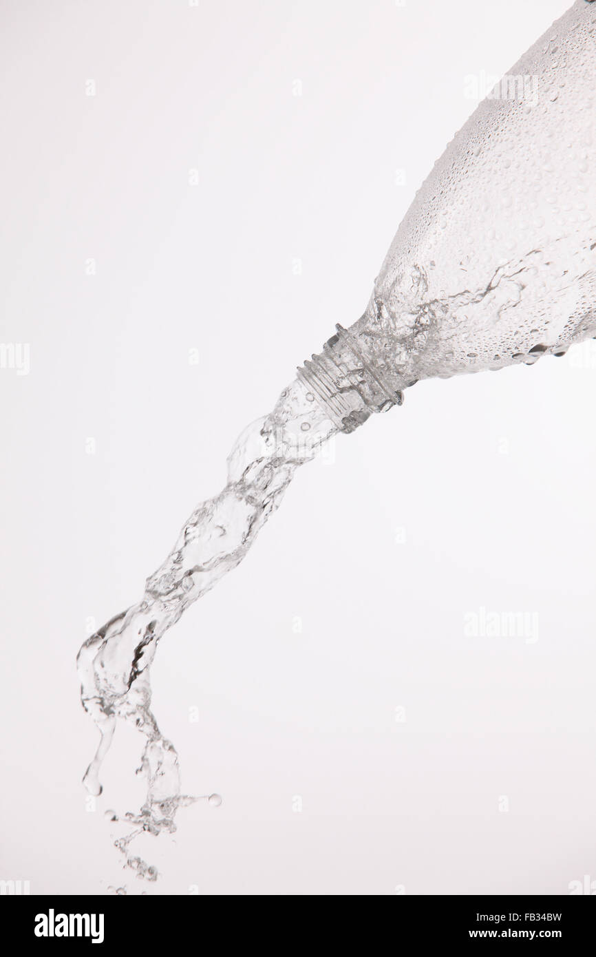 bottle with water splash out Stock Photo - Alamy