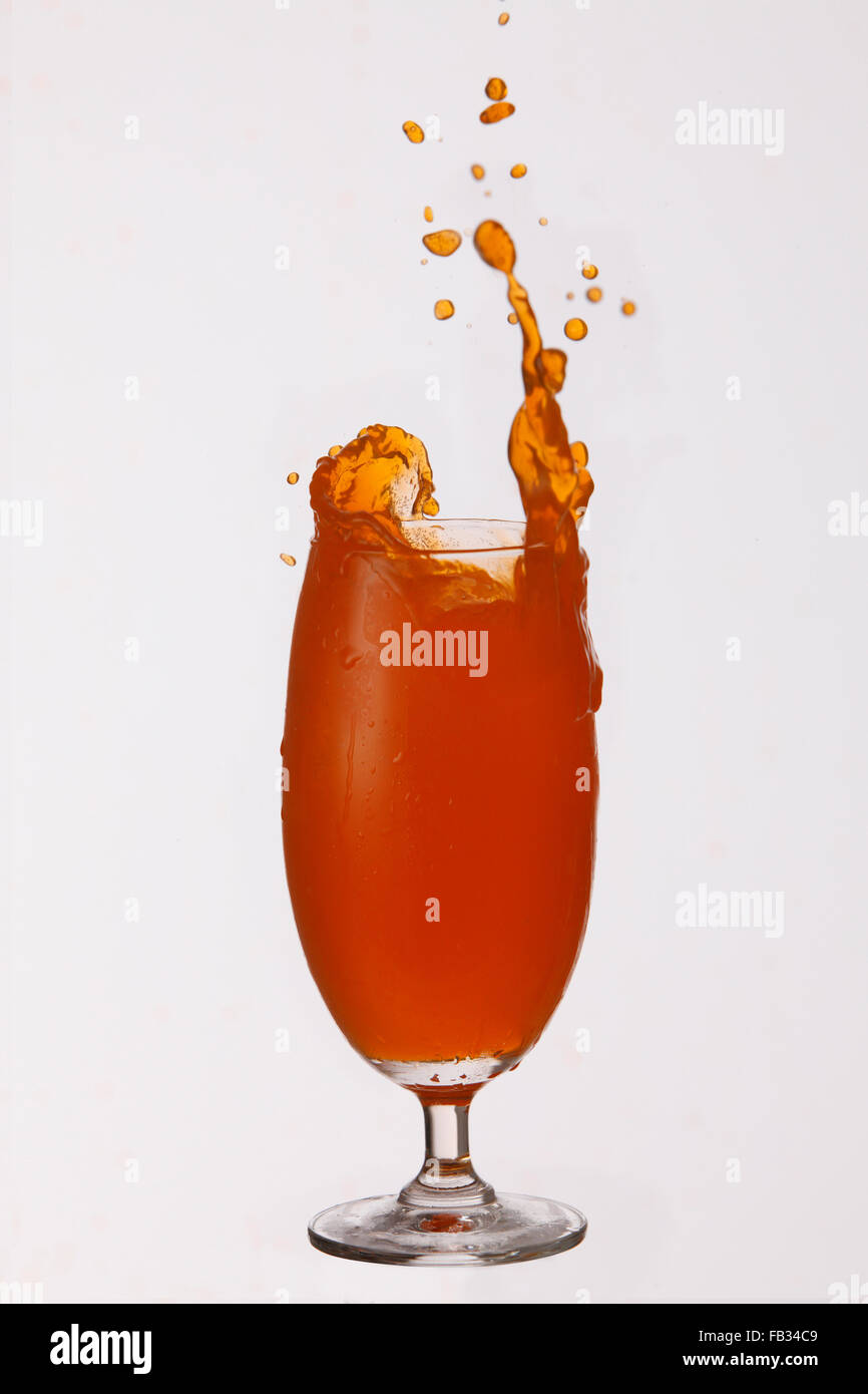 orange soda with splash on the plain background Stock Photo - Alamy