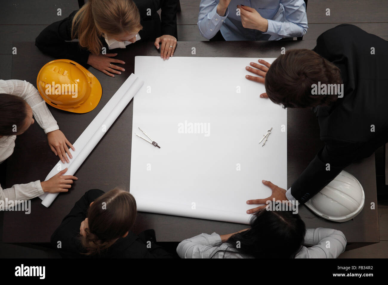 Top view of people around table in construction business meeting Stock ...