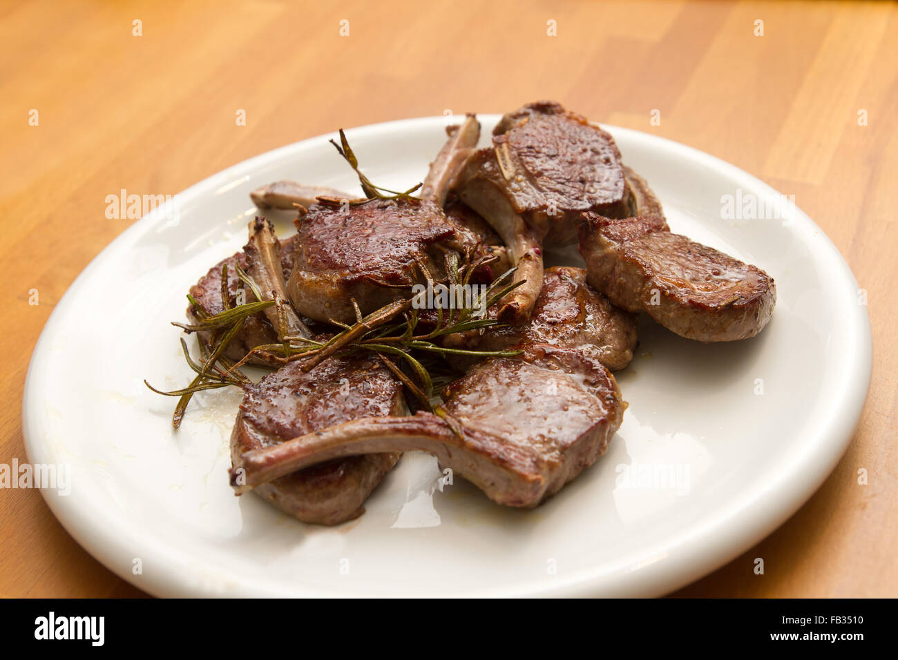 Lamb racks with tomatoes and feta cheese Stock Photo - Alamy