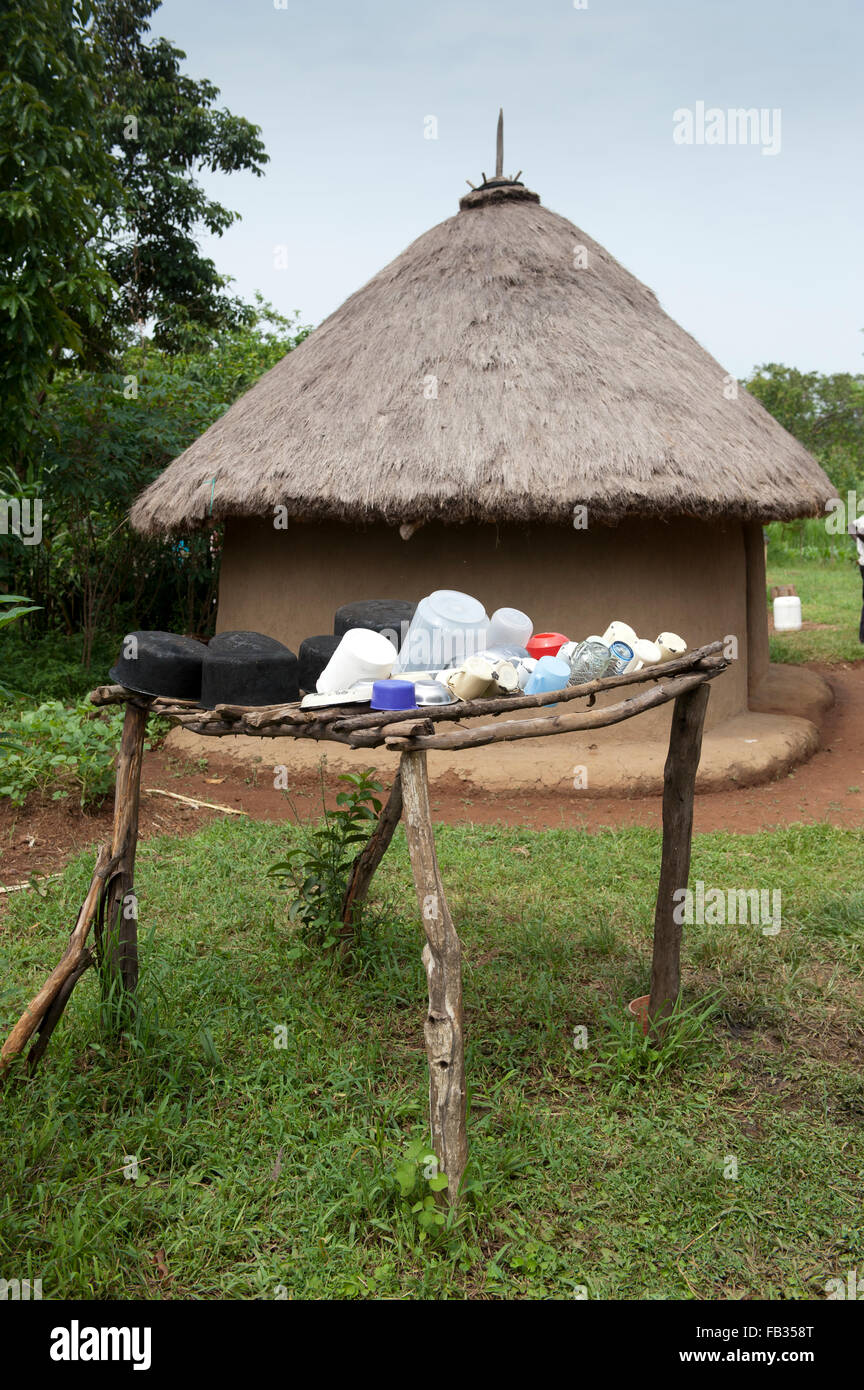 Kitchen utensils drying on a washing rack outside rural village home ...