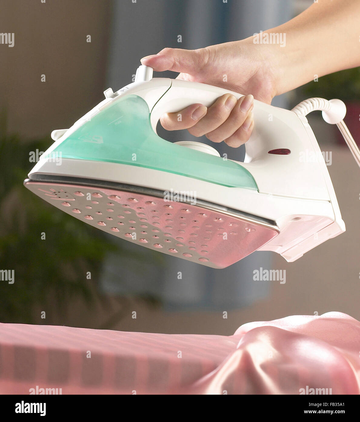 A person ironing some clothes Stock Photo - Alamy