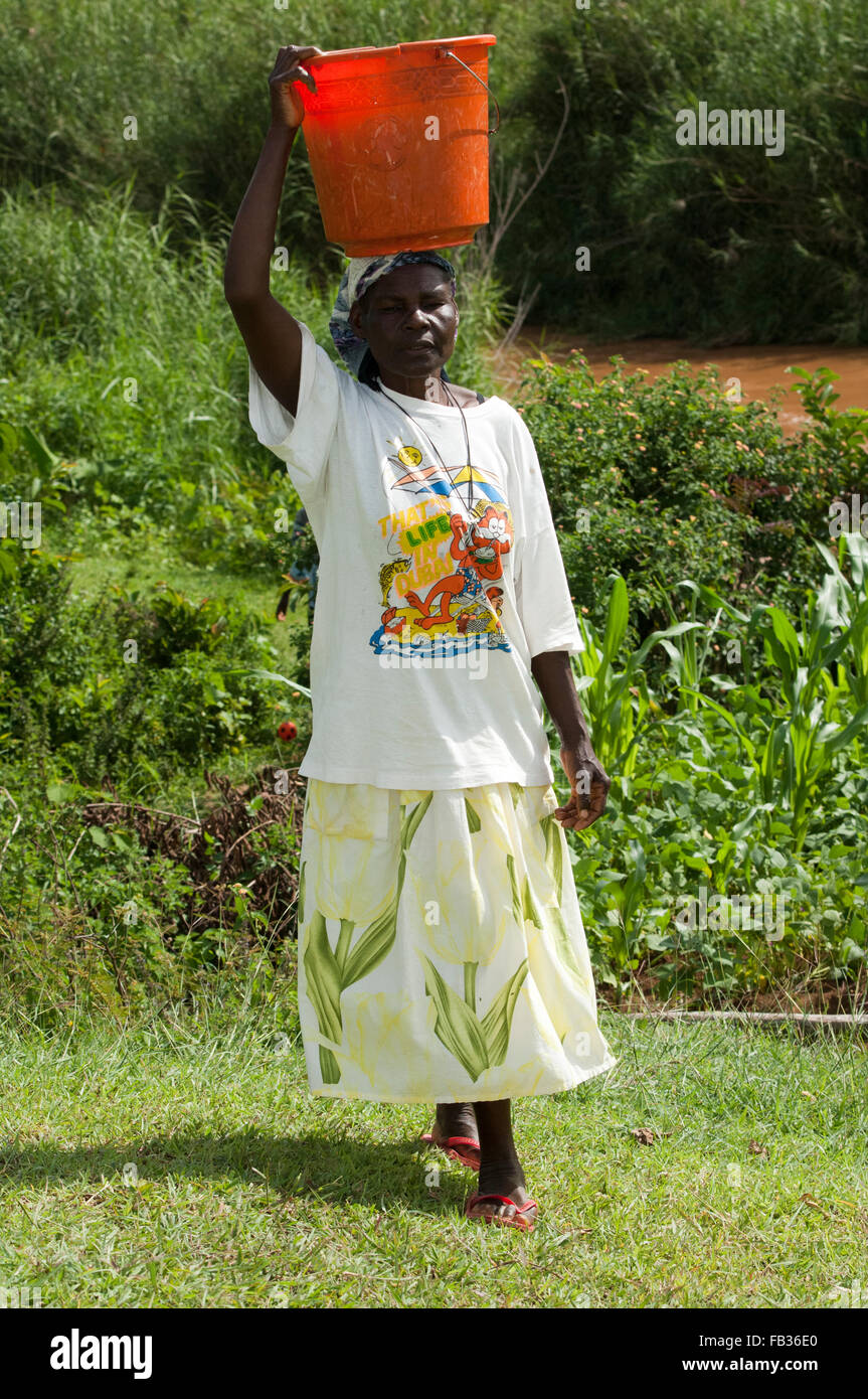 African woman carrying bucket on head High Resolution Stock Photography ...