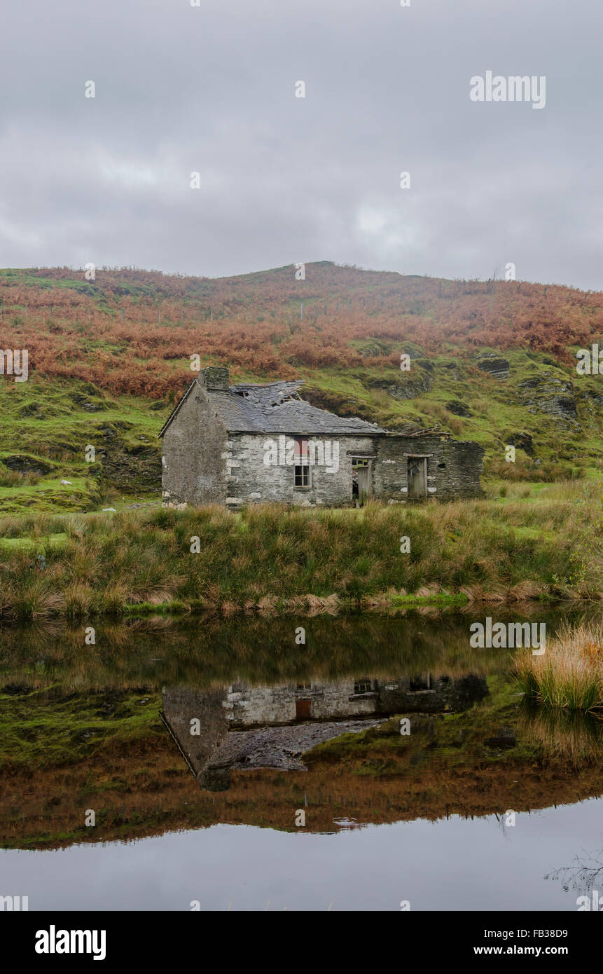 Beautiful walk reveals the landscape of a ruined cottage reflected in a ...