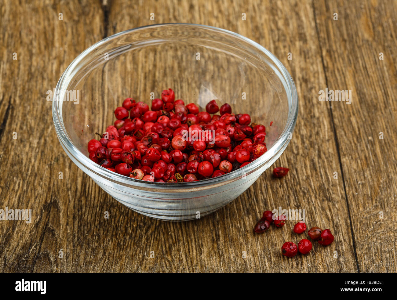 Dry Rose pepper corn on the wood background Stock Photo - Alamy