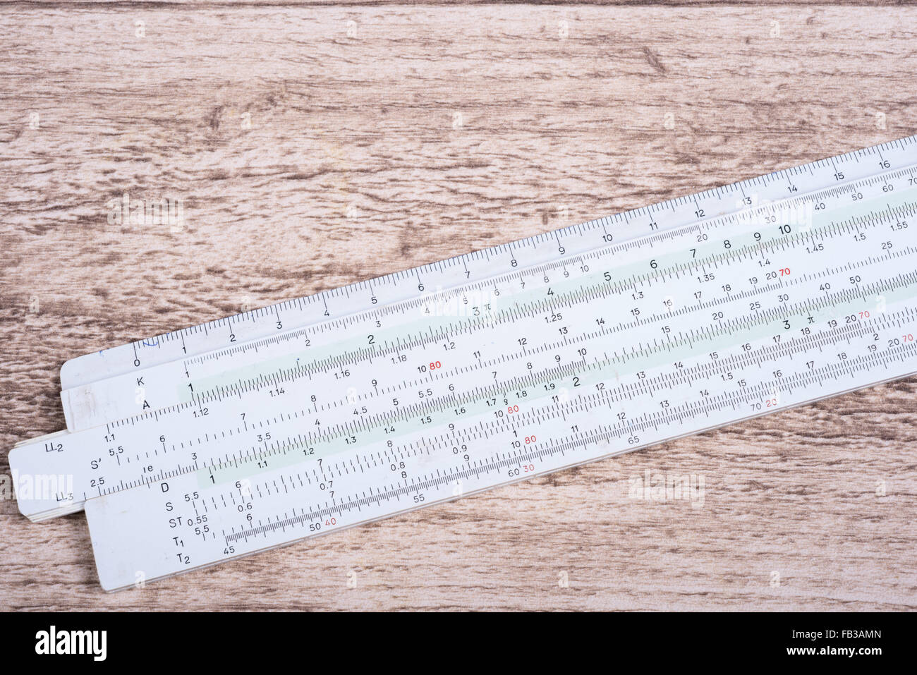 historic slide rule lying on wooden table Stock Photo - Alamy