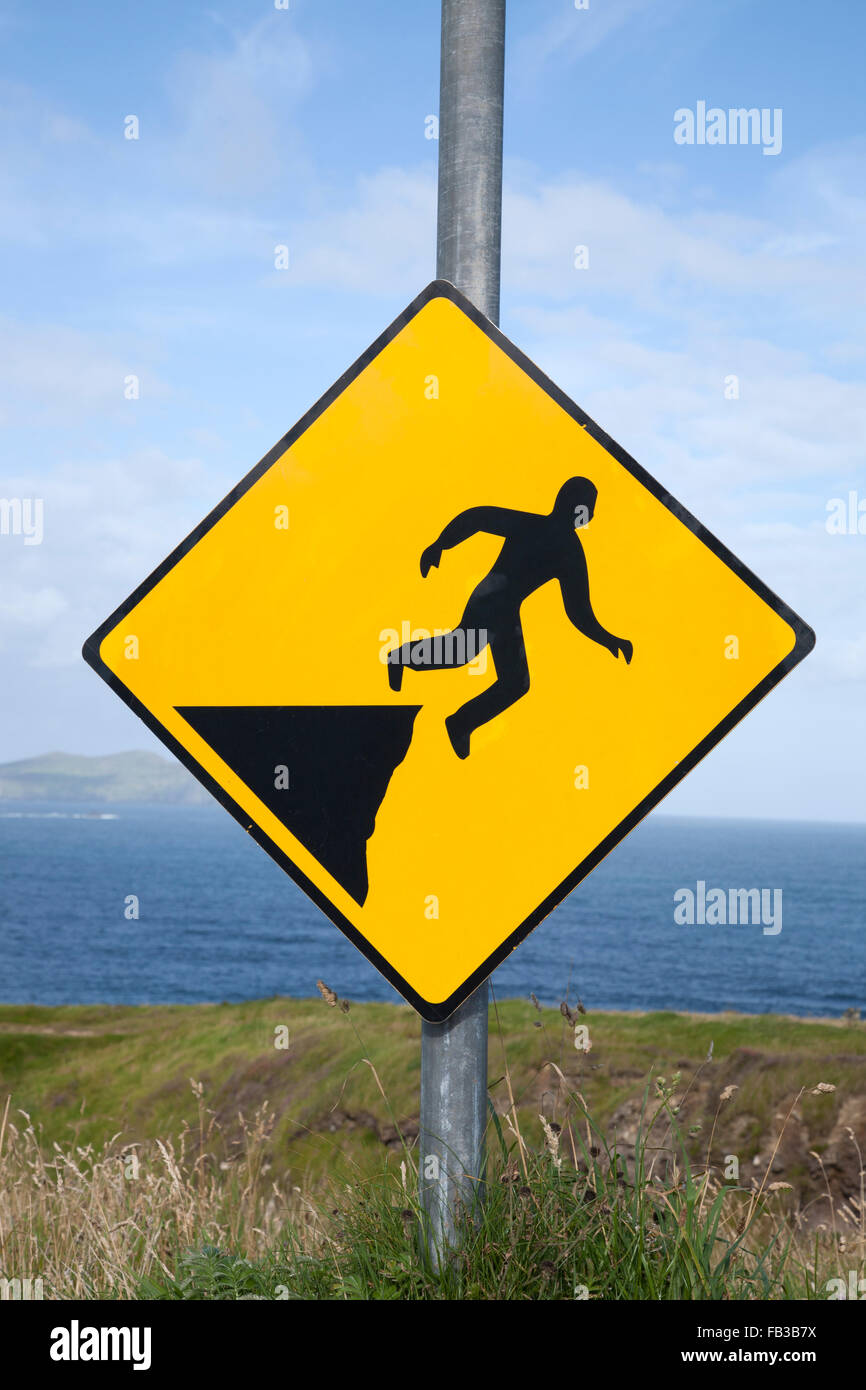 Yellow Cliff Sign with Coastal Background Stock Photo - Alamy